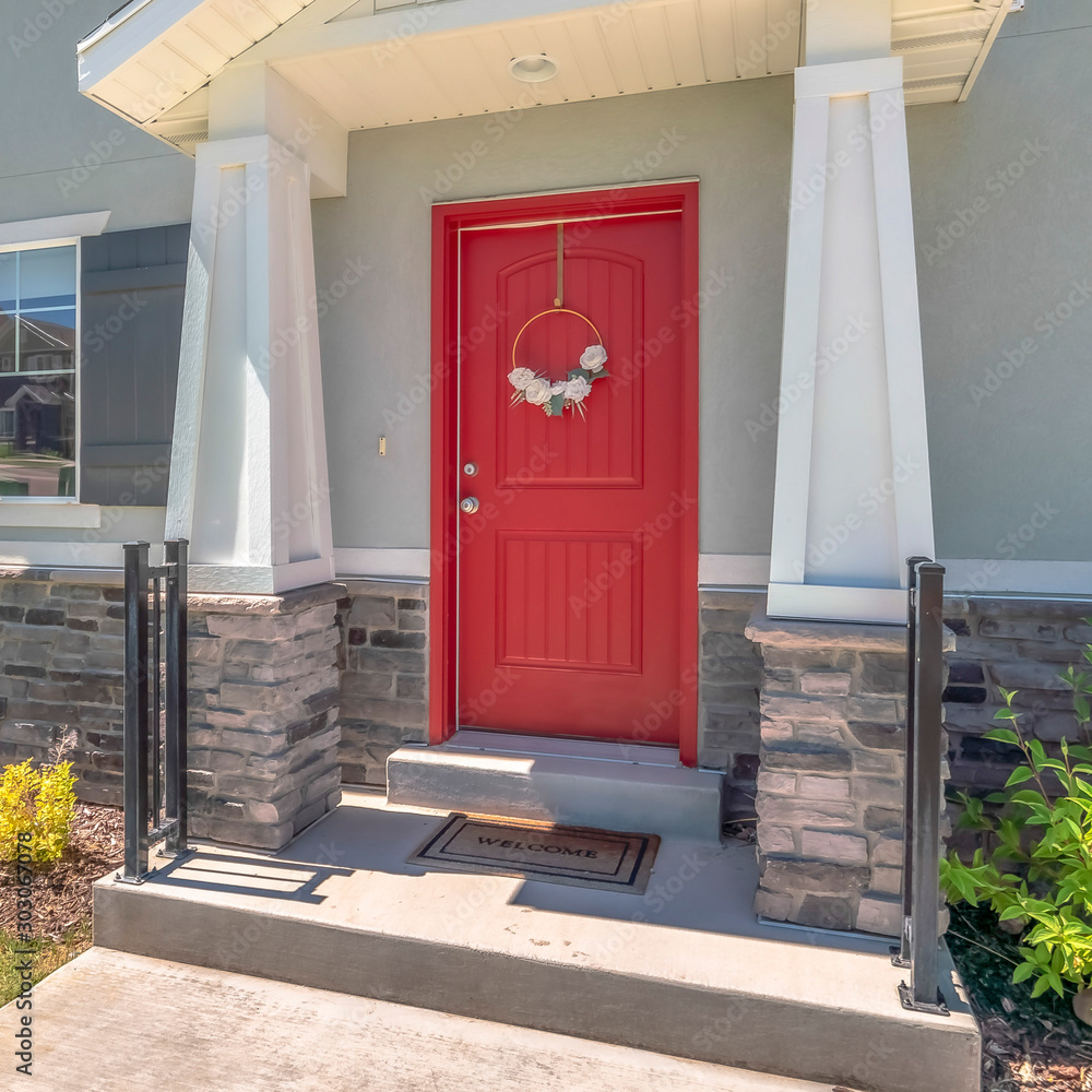 Square Piched roof over the vivid red front door with pillars and ...