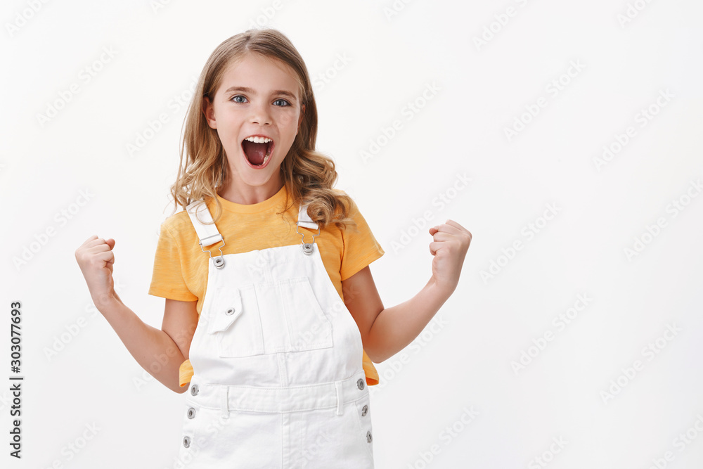 Proud good-looking young satisfied little girl with fair hair and blue ...