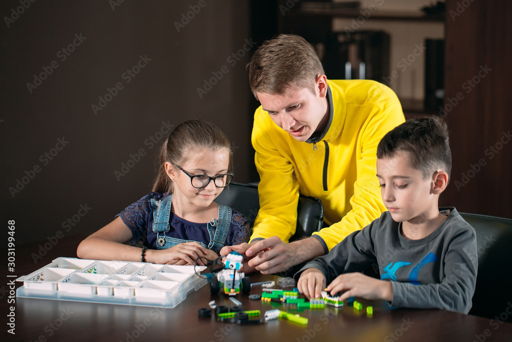 Kids creating robots with teacher. Early development, diy, innovation ...