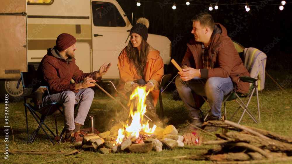 Bearded man telling a funny joke to his friends around camp fire Stock ...