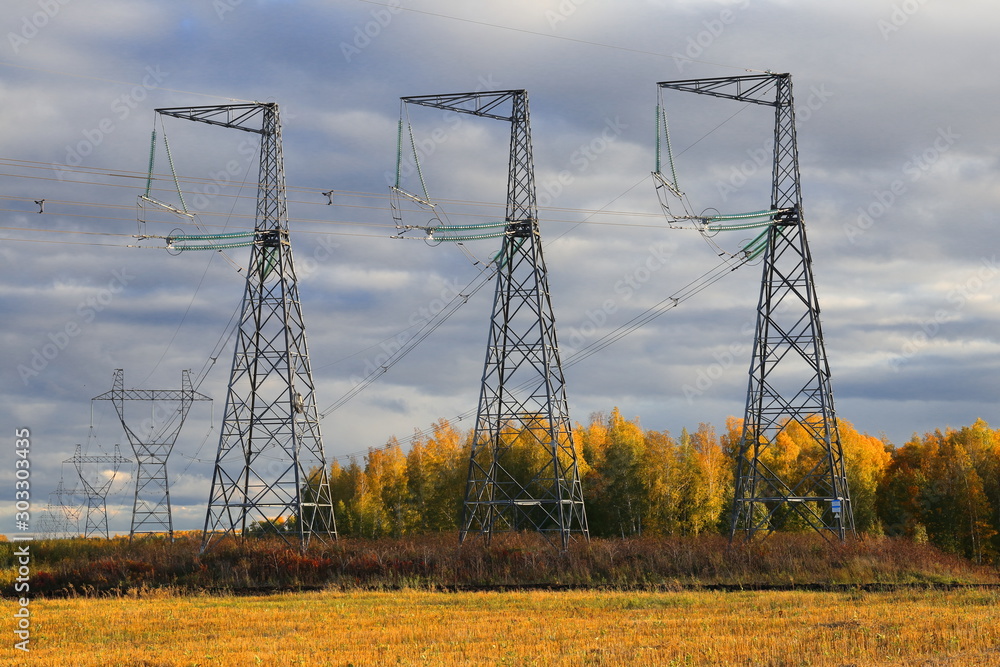 Stockfoto Three electric transmission towers look like giant tall ...