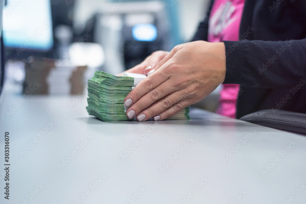 Bank employees sorting and counting money inside bank vault. Large ...
