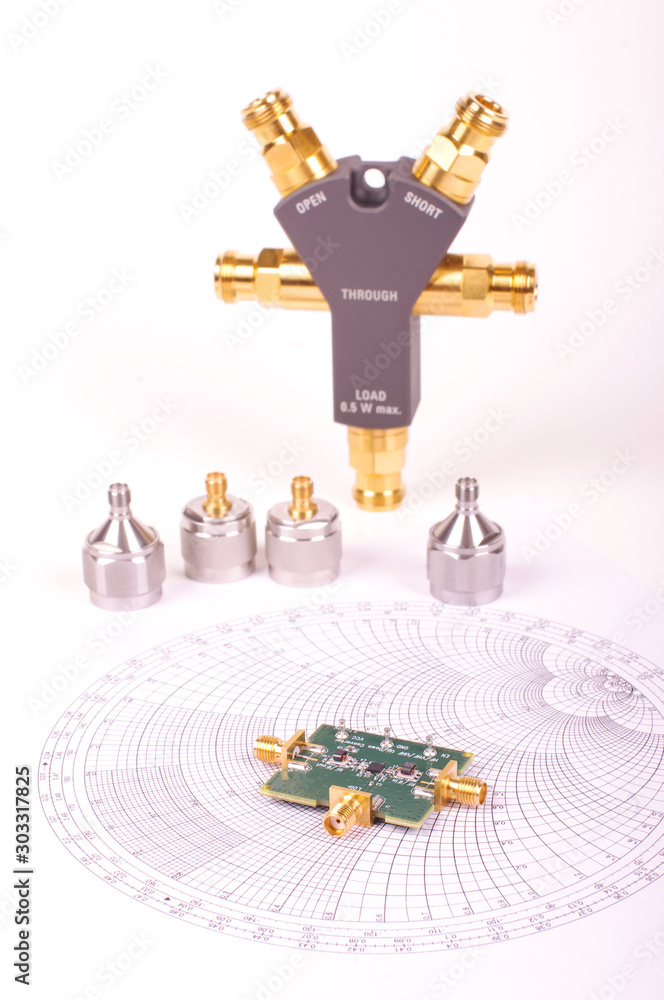 RF mixer electronics PCB in front of Smith chart and other microwave ...