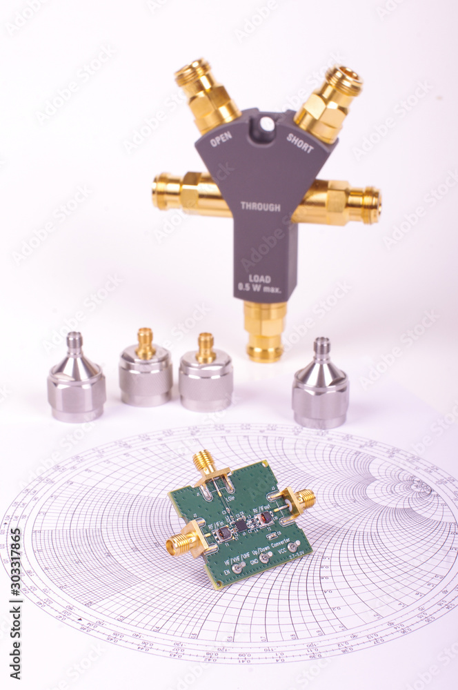 RF mixer electronics PCB in front of Smith chart and other microwave ...