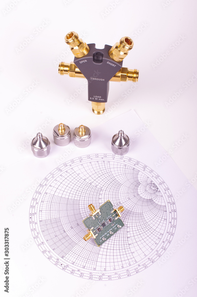 RF mixer electronics PCB in front of Smith chart and other microwave ...