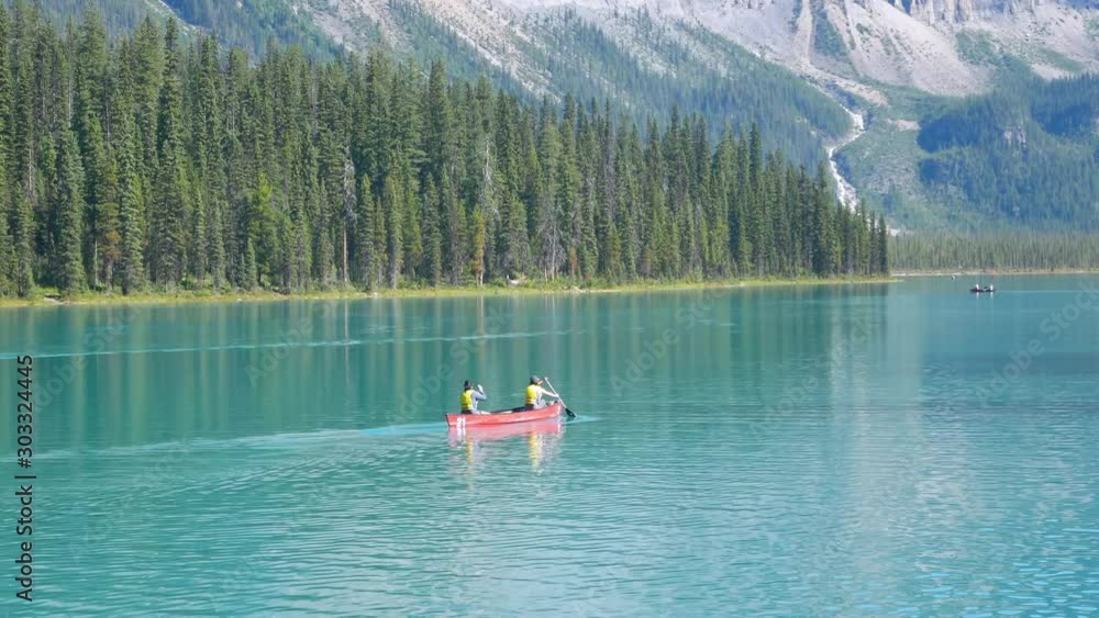 summer clear blue lake view(Emerald Lake) with people canoeing in lake ...