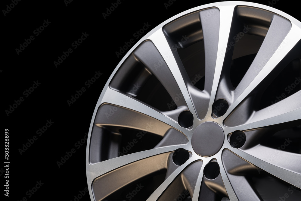 car alloy wheel close up, beautiful design of smooth curved spokes ...