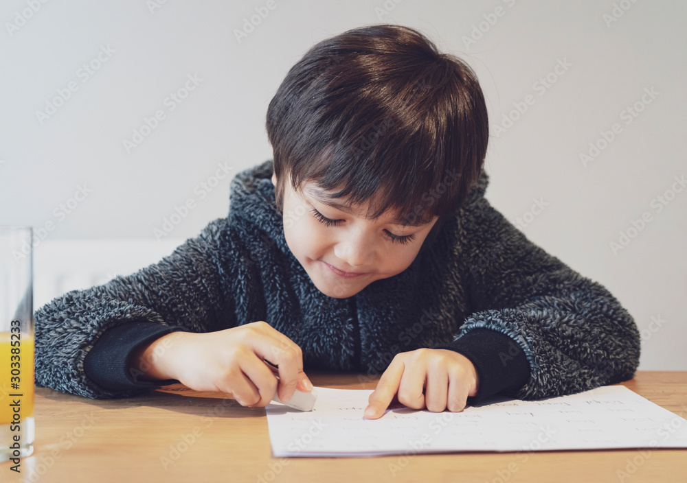 Portrait of adorable kid doing homework with happy face, Female cute ...