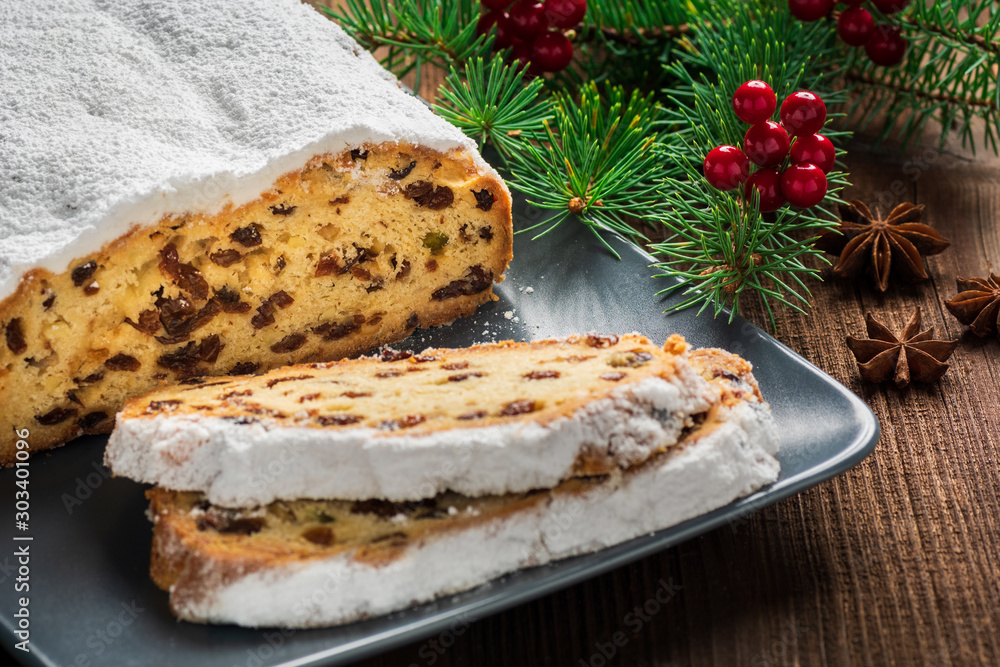 Christmas Stollen on a Plate with a rustic Background and fir branch ...