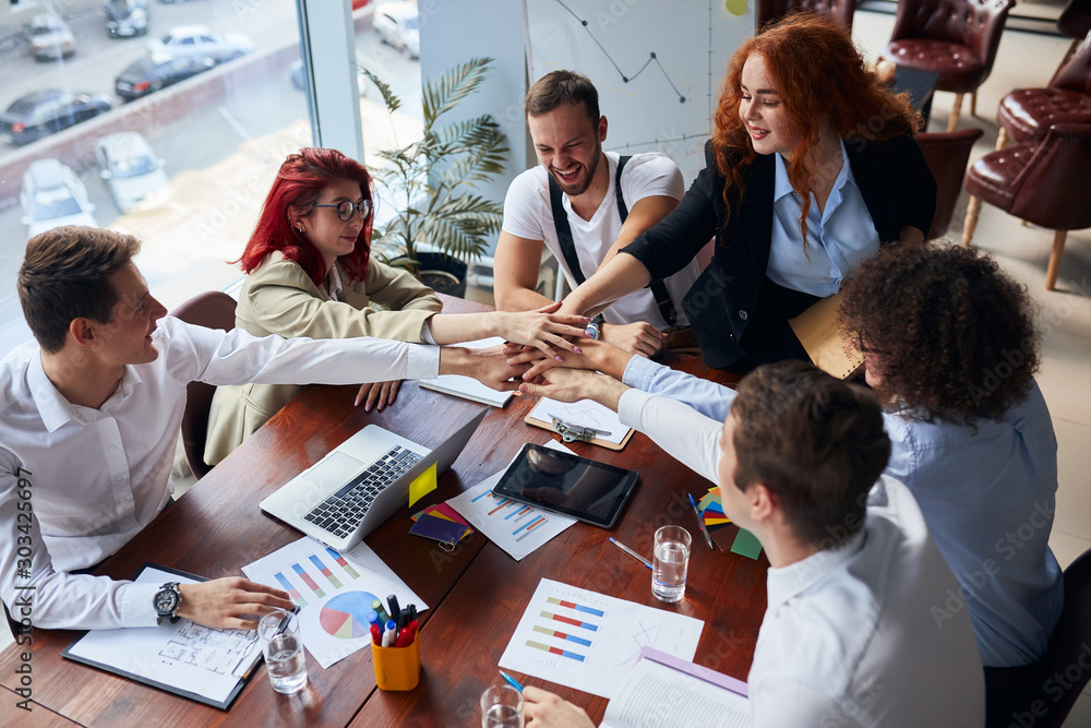 Zdjęcie Stock: Positive group of co-workers joined hands together ...
