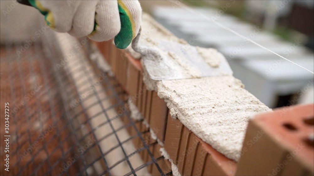 Bricklaying isolated on white. Brickwork, brick house construction ...