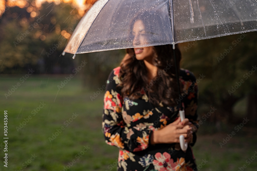 Girl covering upper part of face with transparent umbrella , fall ...