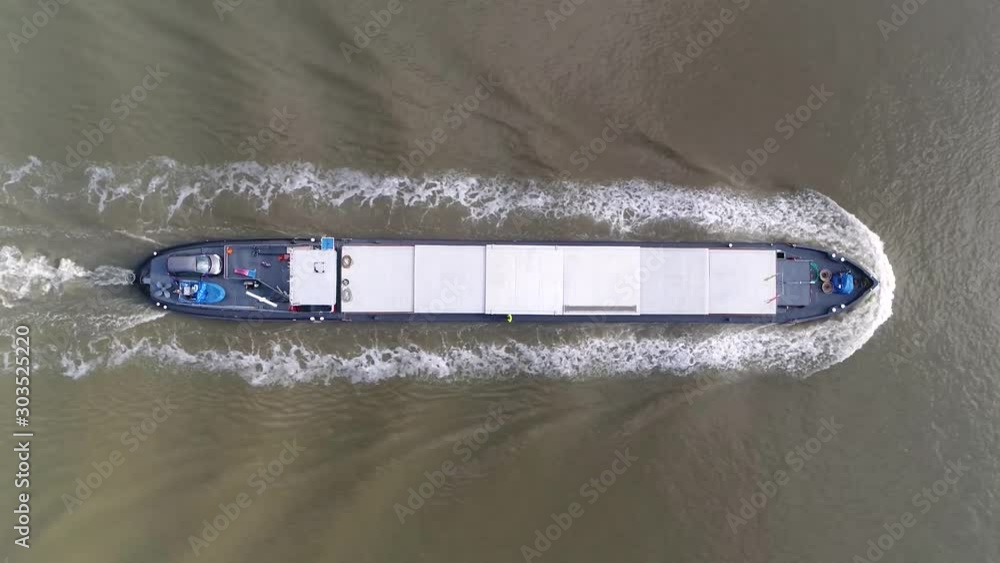 Aerial top down view of barge moving over water this flat-bottomed boat ...