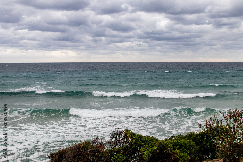 stormy sea on the Mediterranean coast, rain on the sea with high waves ...