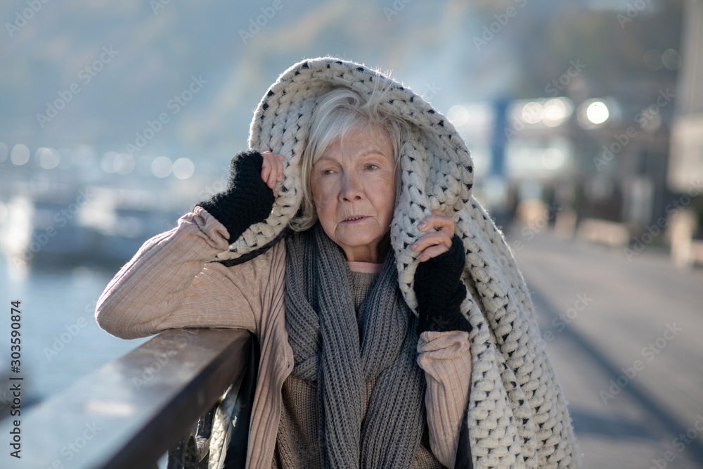 Poor homeless woman feeling very cold thus putting coat on head Stock ...