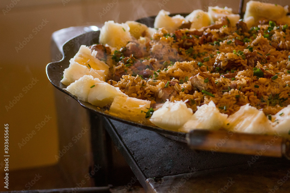 Paella caipira emitting smoke, traditional dish from brazilian ...