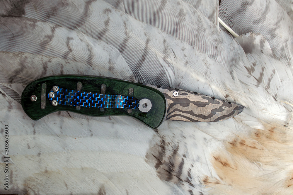 The pocket clip on the back of a liner lock folder with damascus blade ...