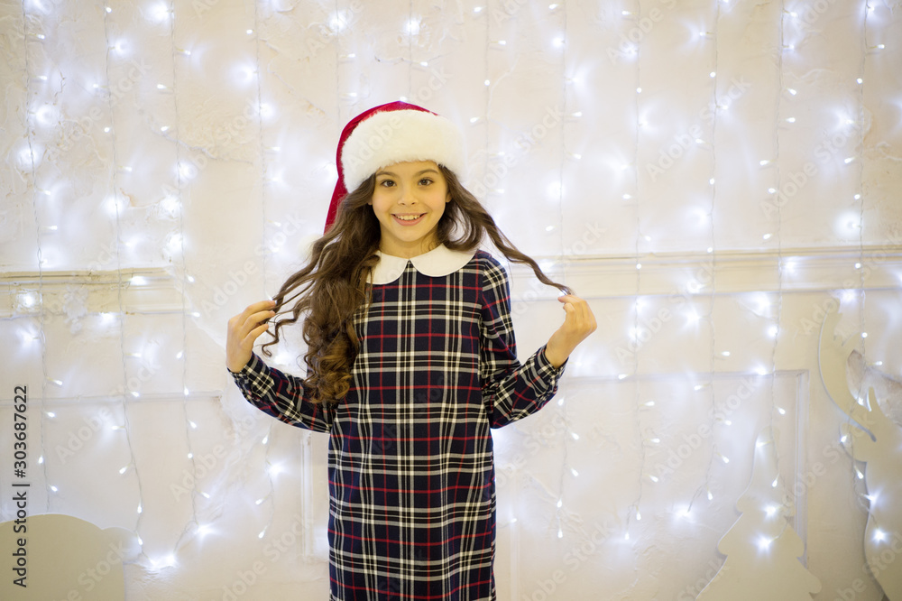 Happy winter holidays. Small girl at home garland lights. Kid relaxing ...