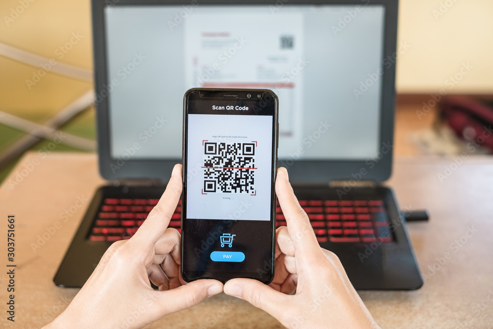 Close up of hand smartphone to make mobile wallet payment via QR code ...