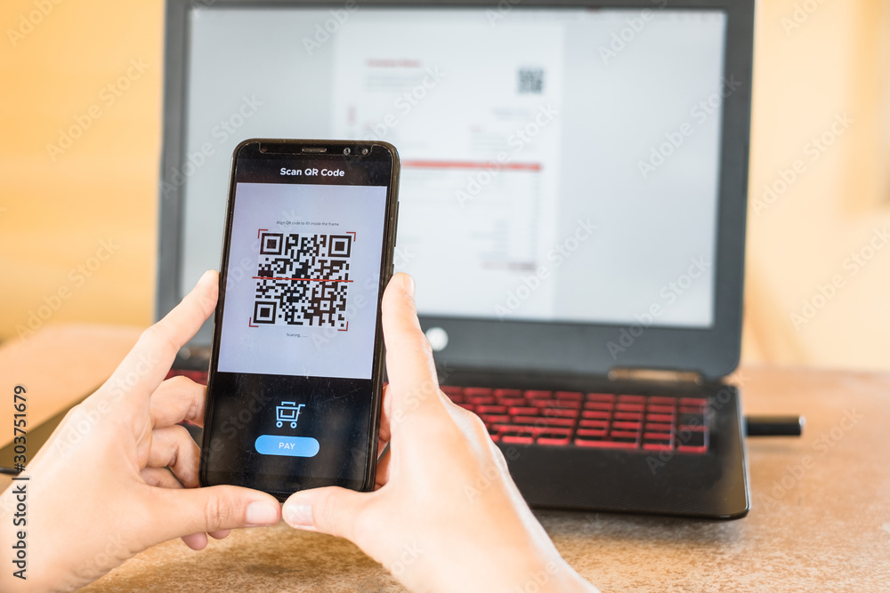 Close up of hand smartphone to make mobile wallet payment via QR code ...