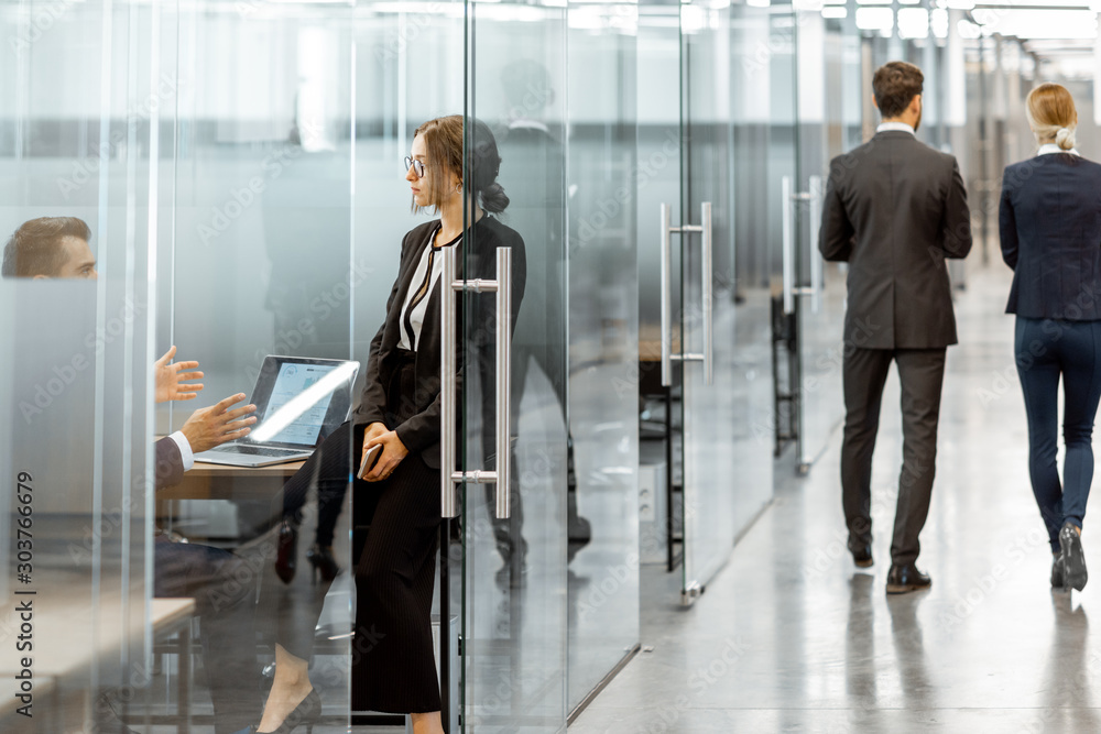 Business people walking in the hallway of the modern office building ...