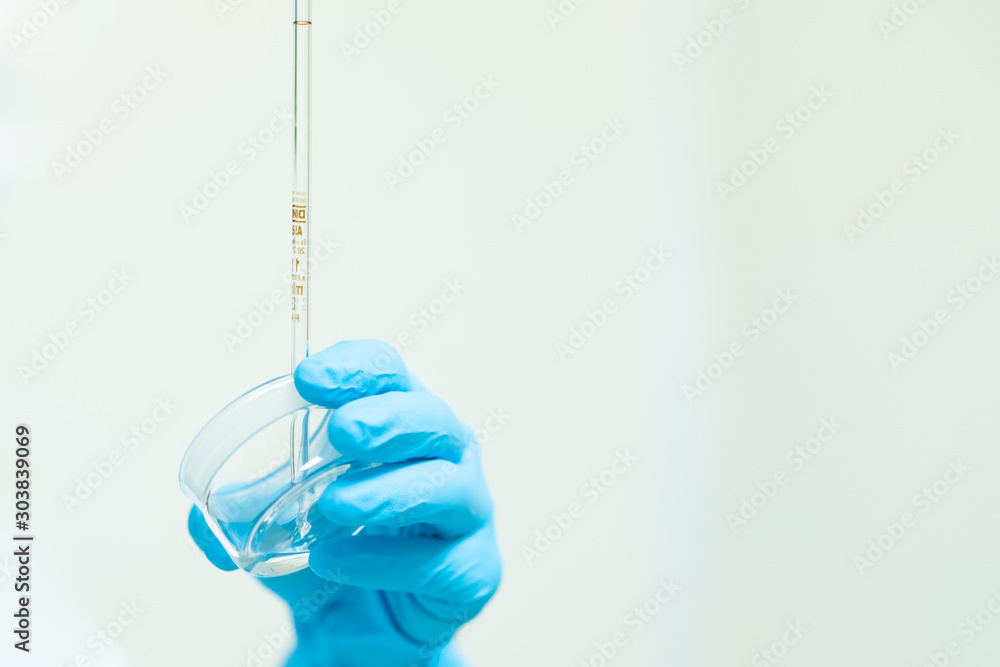 The operator is adjust volume water in volumetric pipette for ...