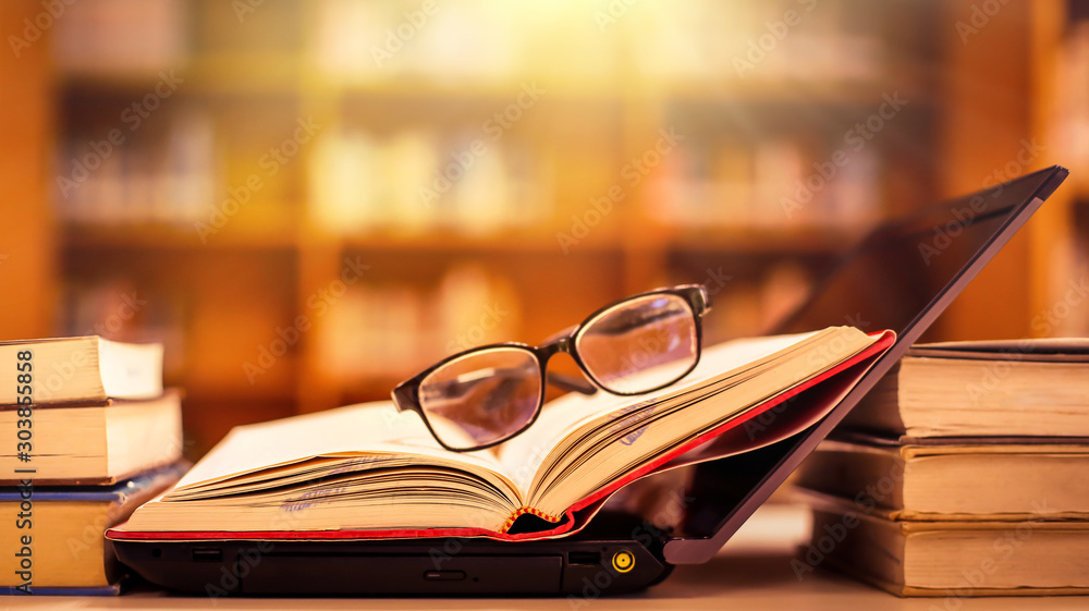 Stack of books with Glasses placed on the open book in library. Stock ...