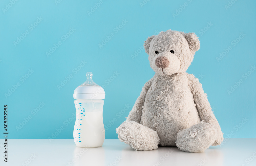 Baby feeding concept. Bottle of milk next to teddy bear. Stock Photo ...