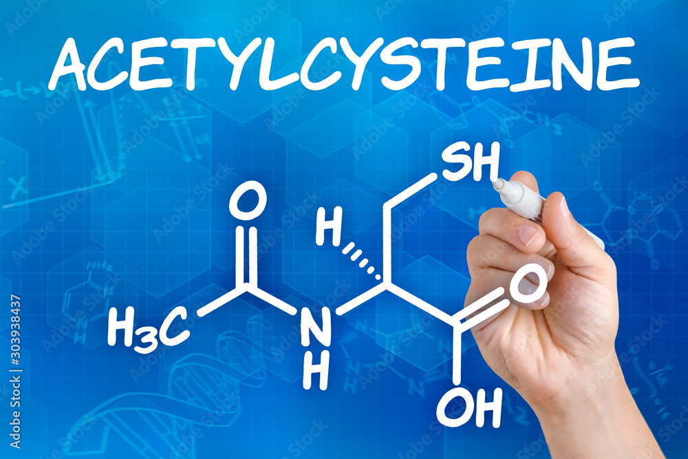 Hand with pen drawing the chemical formula of acetylcysteine Stock ...