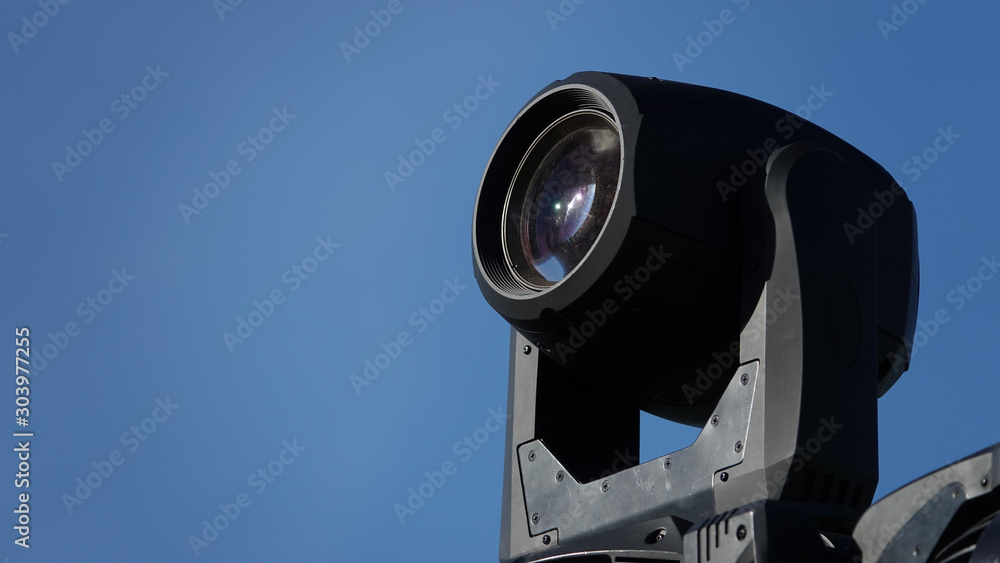 Moving spotlight set up for outdoor event, seen against a blue sky with ...