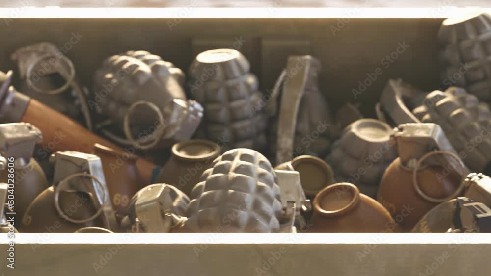 Close up of piled up different types of grenades in wooden ammunition ...