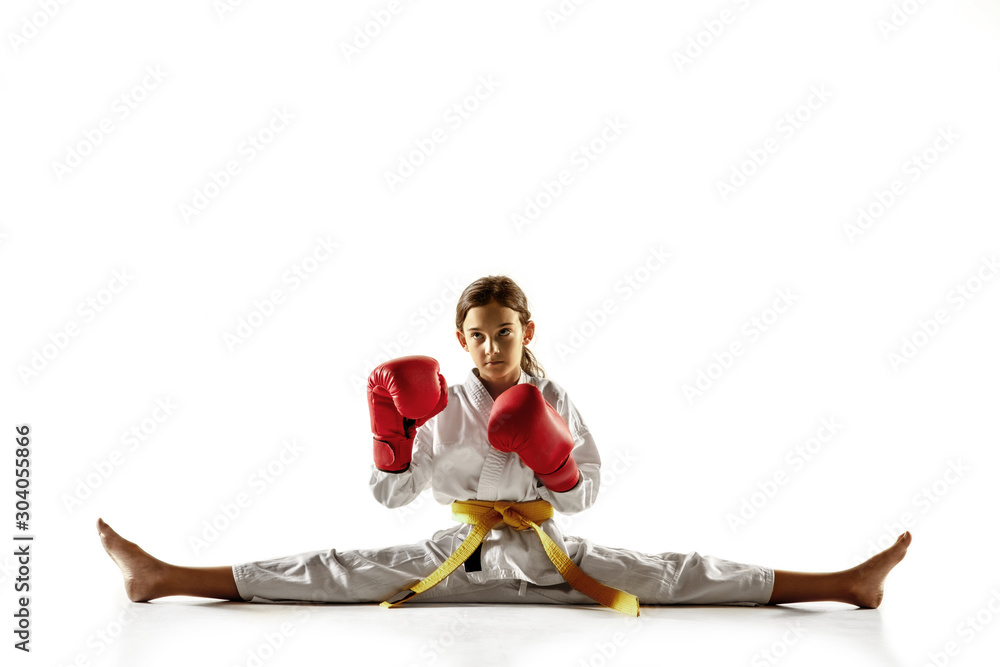 Confident junior in kimono practicing hand-to-hand combat, martial arts ...