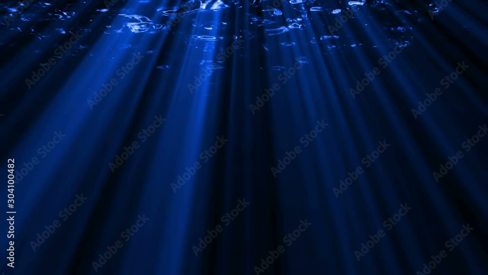 Volumetric rays of light shining from above penetrate through the thick ...