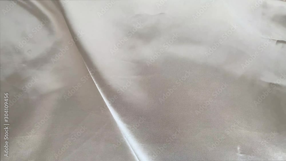 beautiful silk fabric of white color, draped with small folds, softly ...