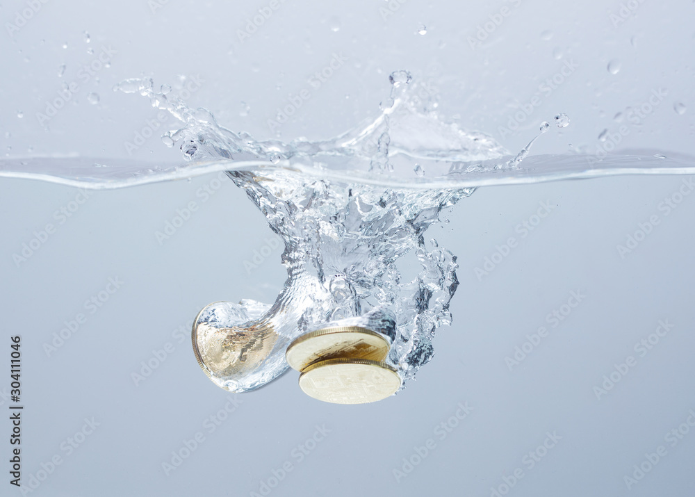 Coins in the water. Splash of coins falling into the water. Coins in ...