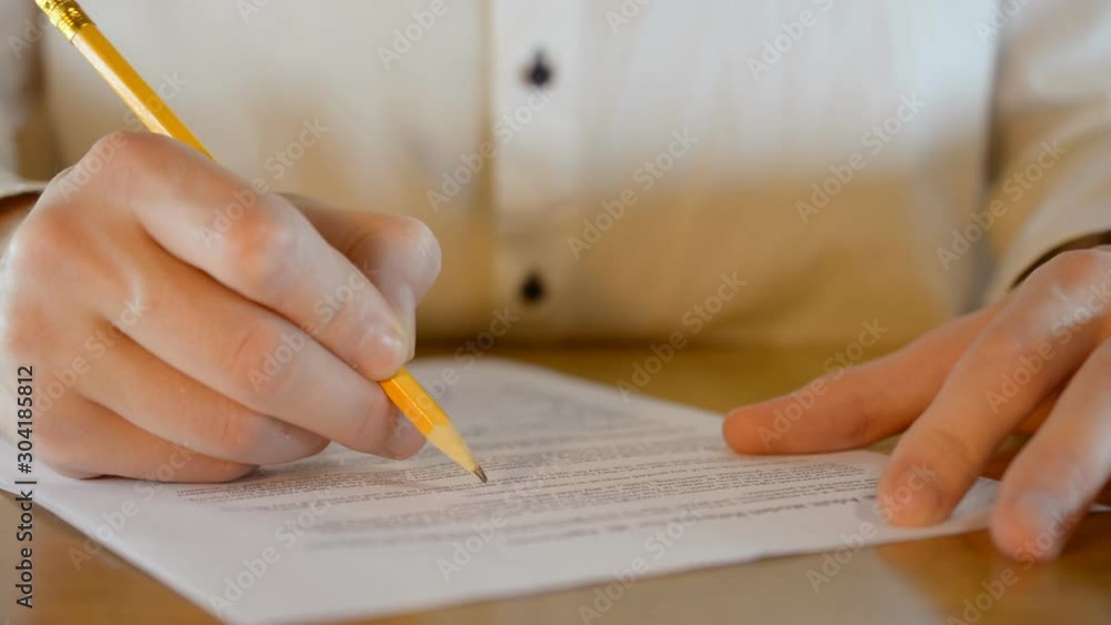 Businessman Reads the contract and highlights important points in the ...