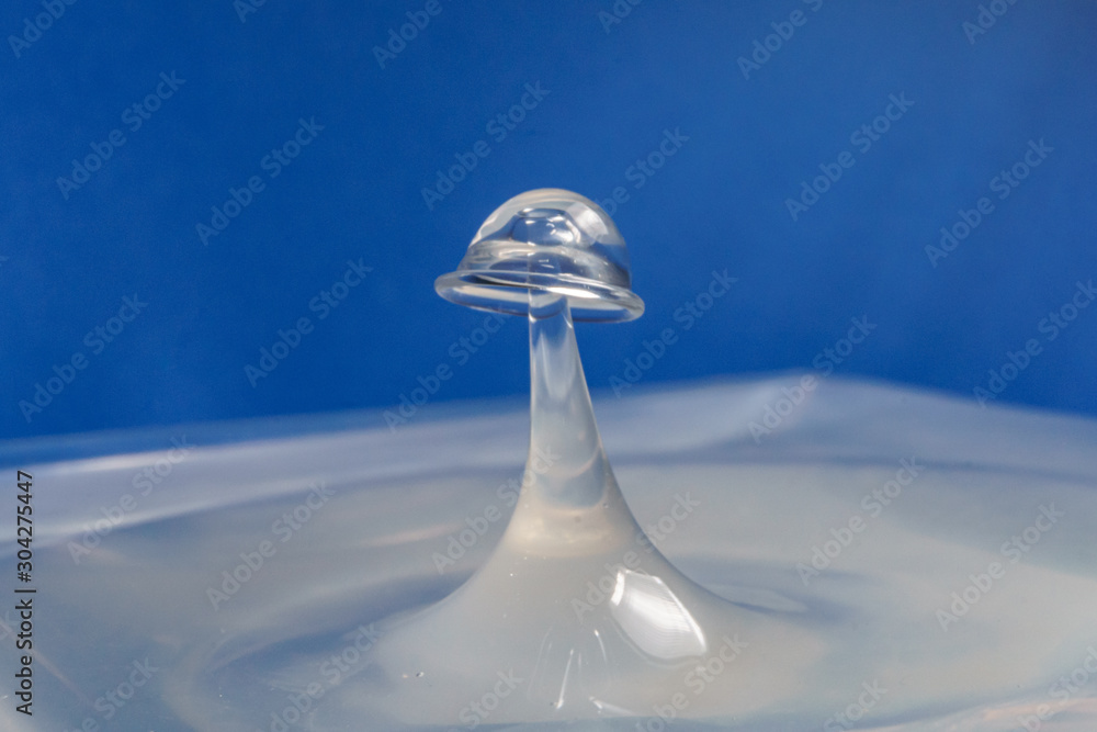 Water drop collision form with blue background Stock Photo | Adobe Stock
