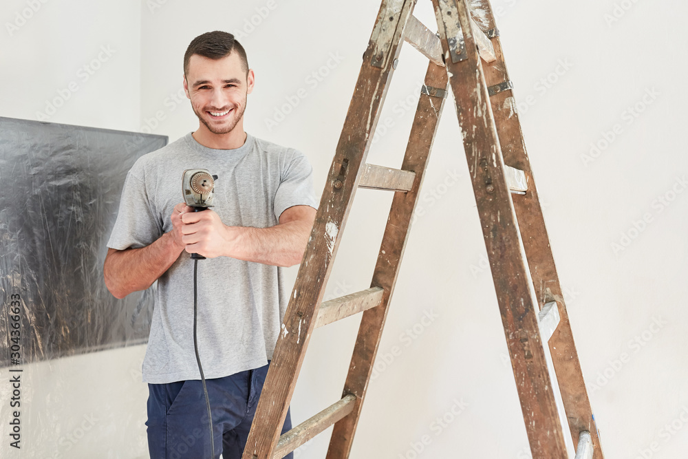 Young man as a handyman with power drill Stock Photo | Adobe Stock