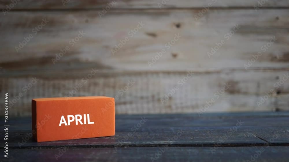 april 16th. Day 16 of month, calendar on a color cubes. hand puts the ...