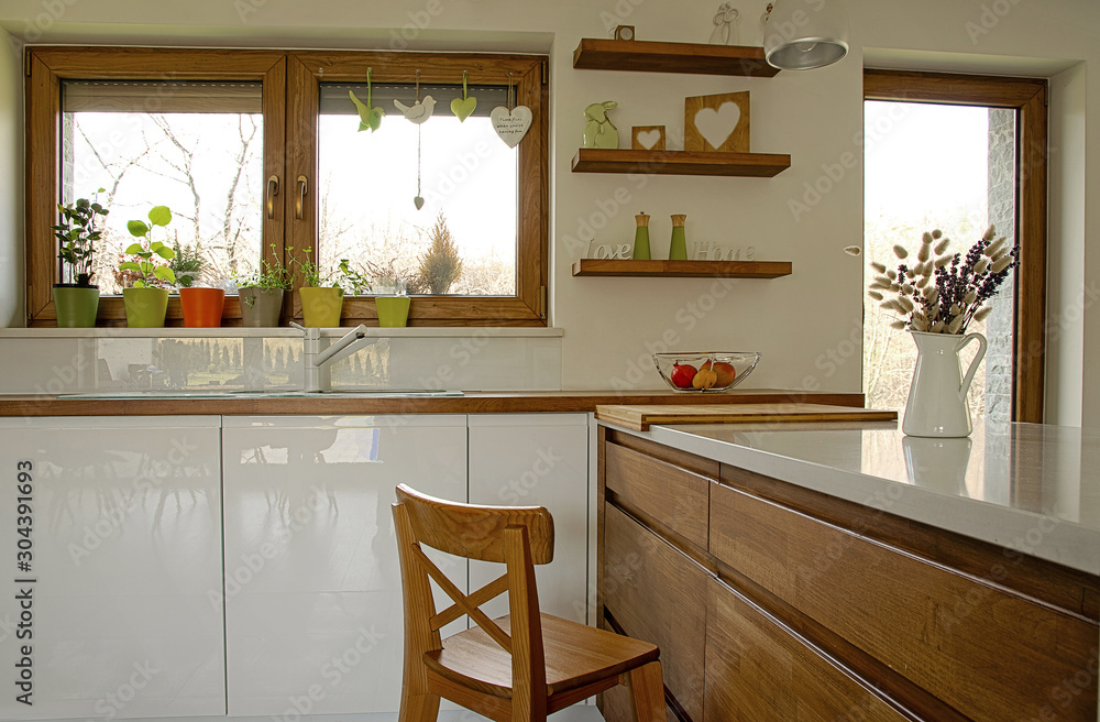 Modern white wooden kitchen with window and shelves. Interior of cozy ...
