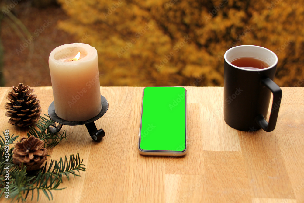 on a wooden table vertically lies a modern telephone with pre-keyed ...