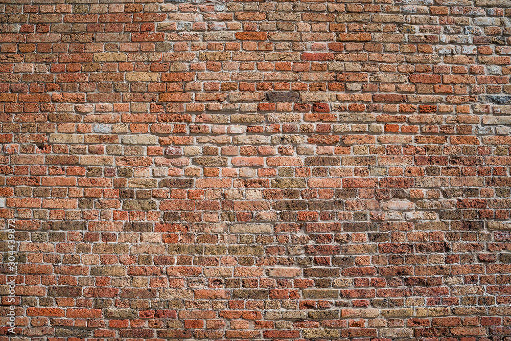 Texture of a medieval brick wall of burgundy, red and brown bricks ...