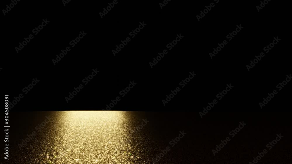 big bright light shining on golden glitter on a black stage, light ...