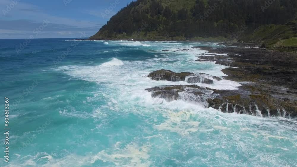 A slow moving low angle aerial view of the rugged and rustic rocky ...