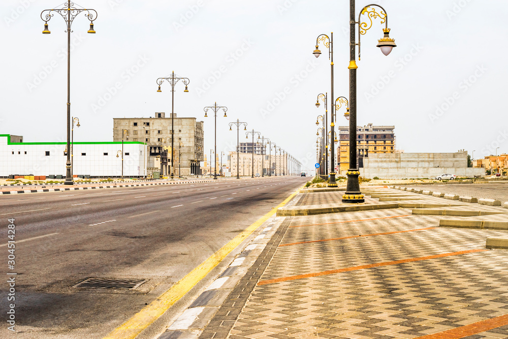 view of an empty newly opened wide street in a modern fast growing city ...