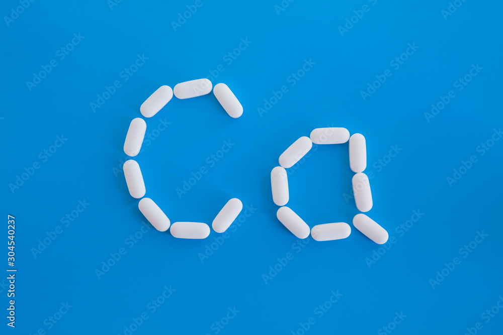 Pills of Calcium supplement formed in Ca element shape in the middle of ...