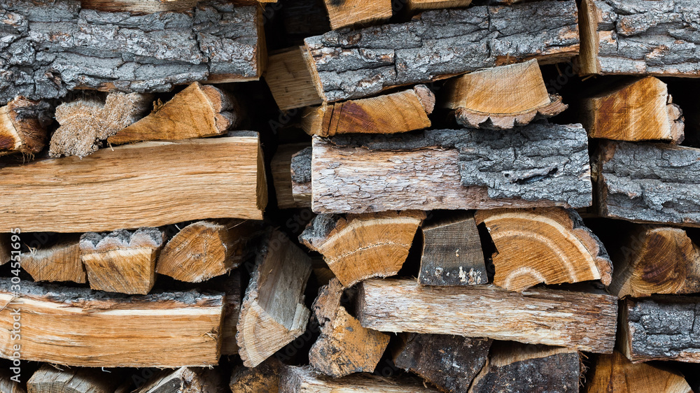 Chopped firewood neatly stacked in a woodpile Stock Photo | Adobe Stock