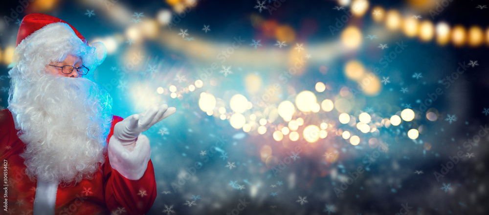 Santa Claus with magic gift in his hands. Portrait of happy Santa Claus ...