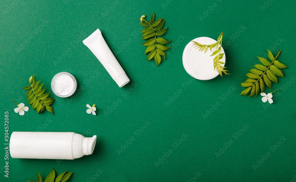 Premium skin care cosmetics, perfume on green rustic background with ...