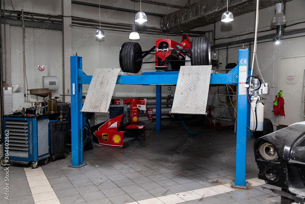 The process of repairing and restoring a red Ferrari Formula 1 car at a ...